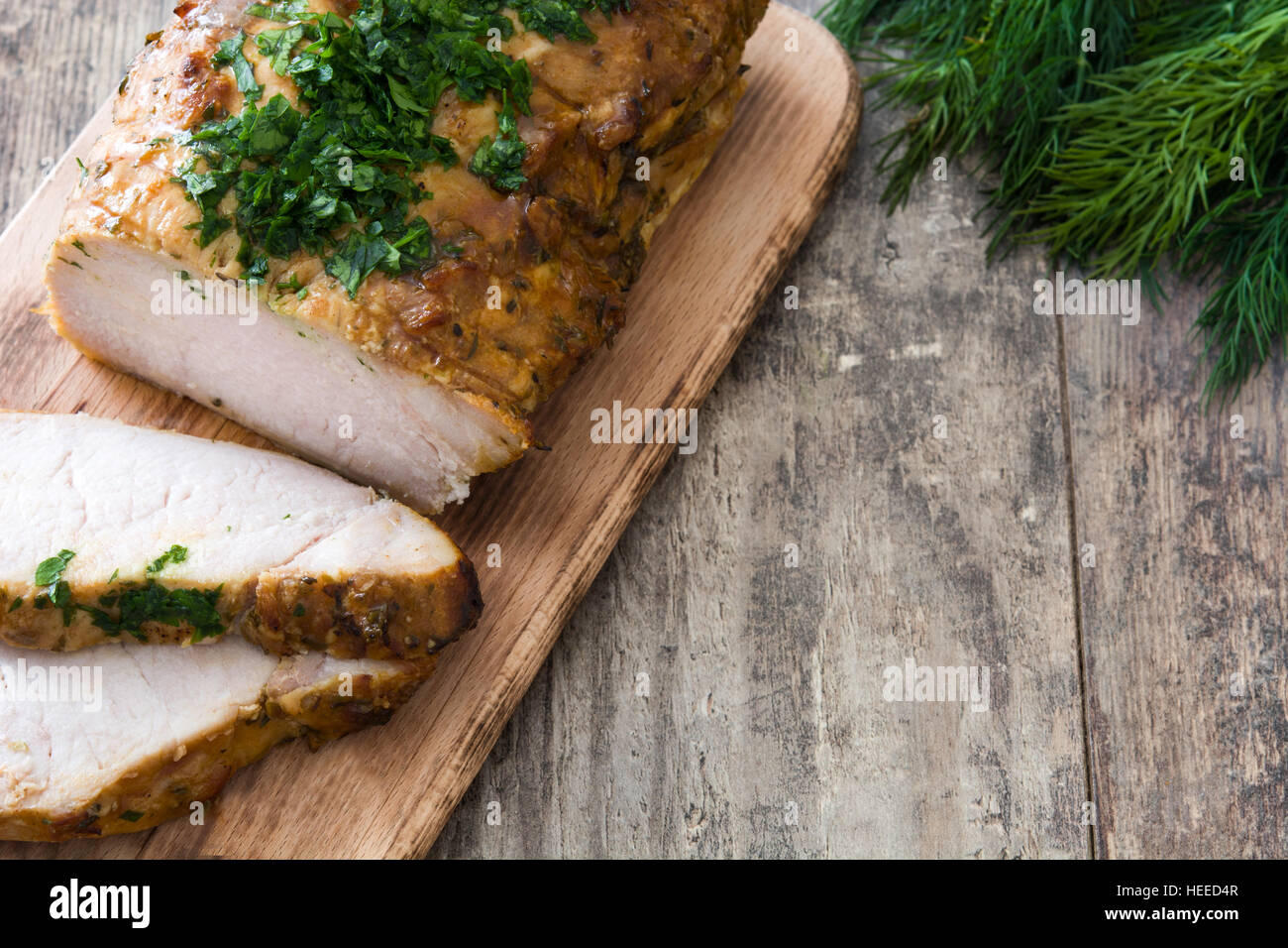 Roasted pork on wooden table Stock Photo - Alamy