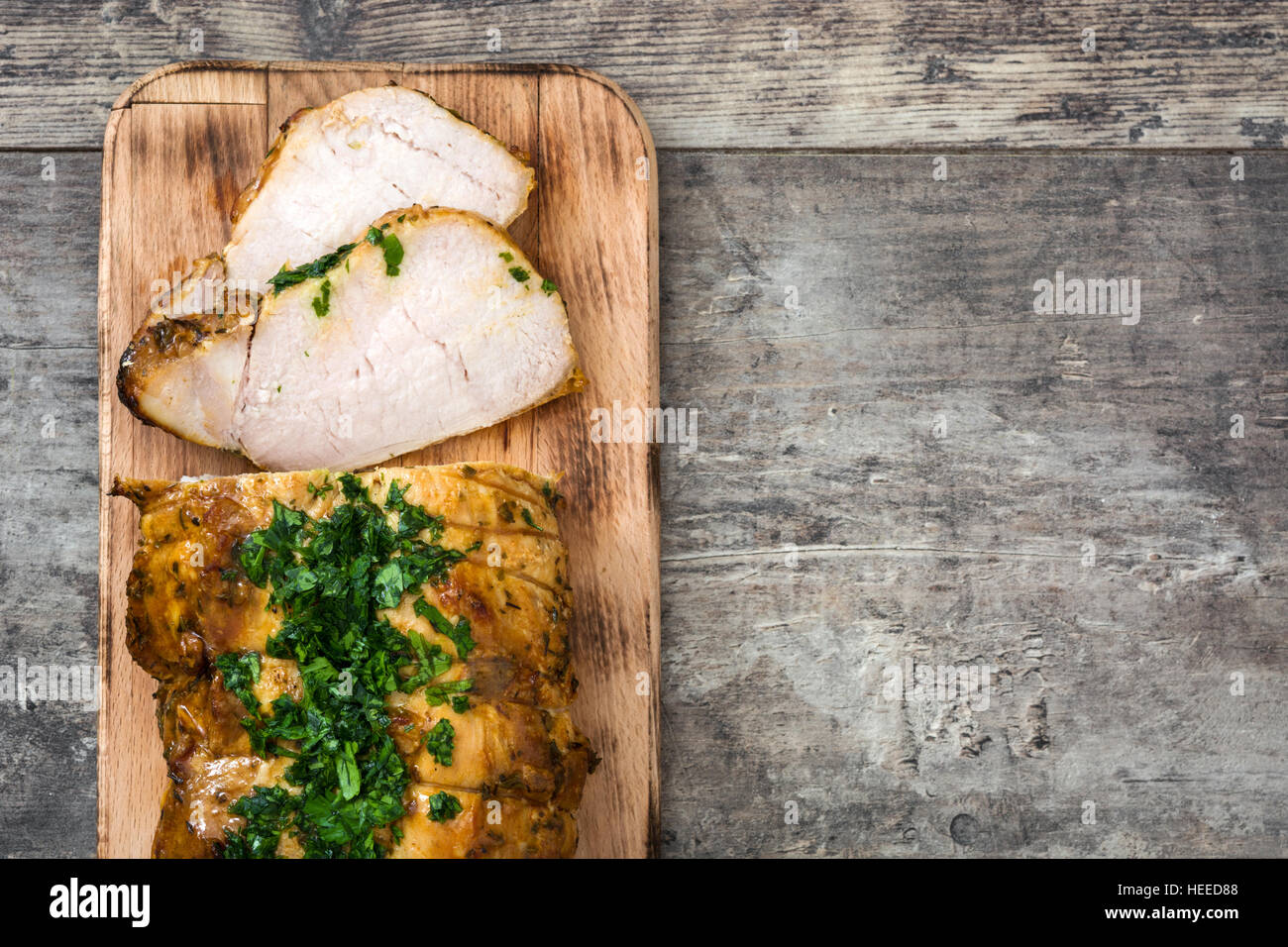Roasted pork on wooden table Stock Photo - Alamy