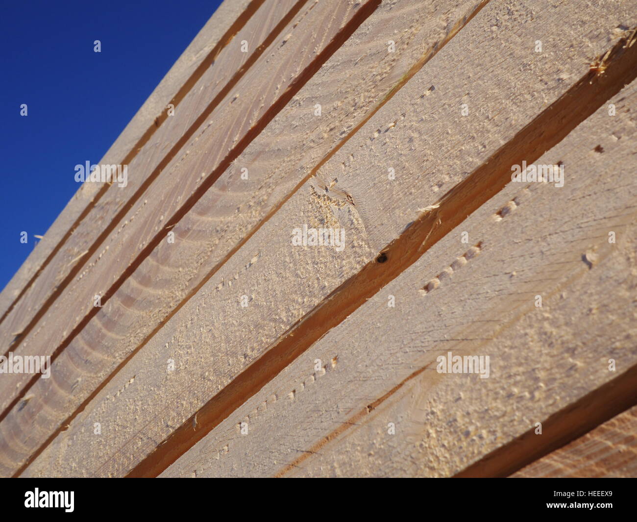Stacks of planks against the deep blue sky Stock Photo - Alamy