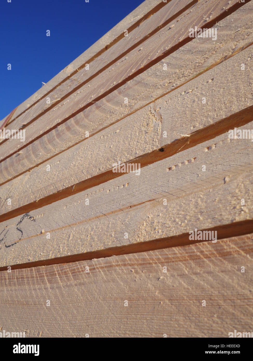Stacks of planks against the deep blue sky Stock Photo - Alamy