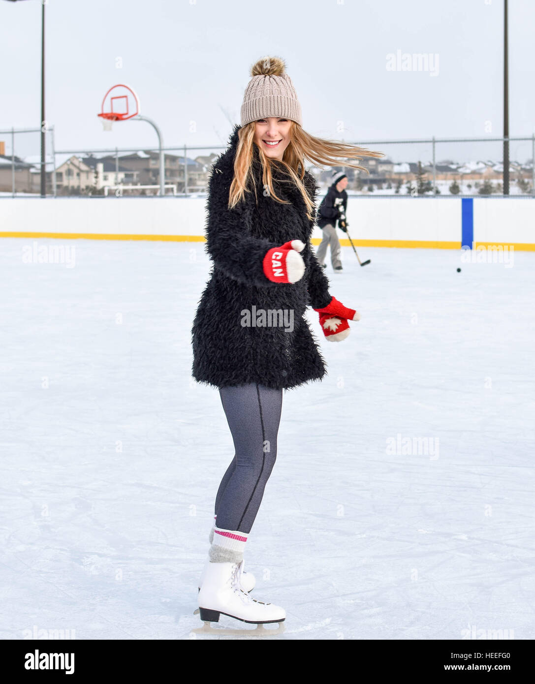 Pretty girl ice skating outdoors Stock Photo - Alamy