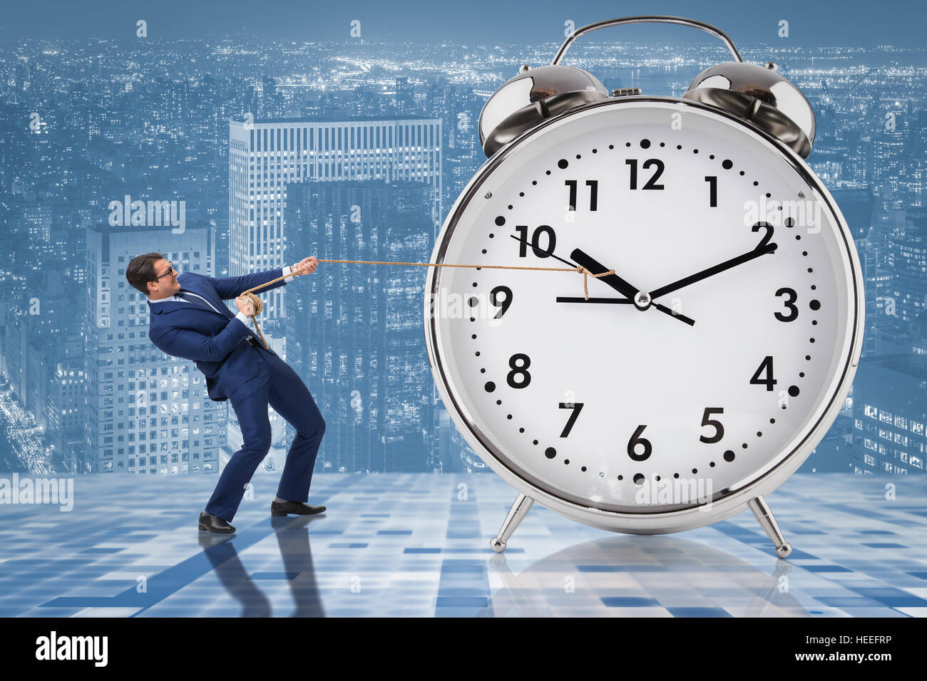 Businessman pulling clock in time management concept Stock Photo - Alamy