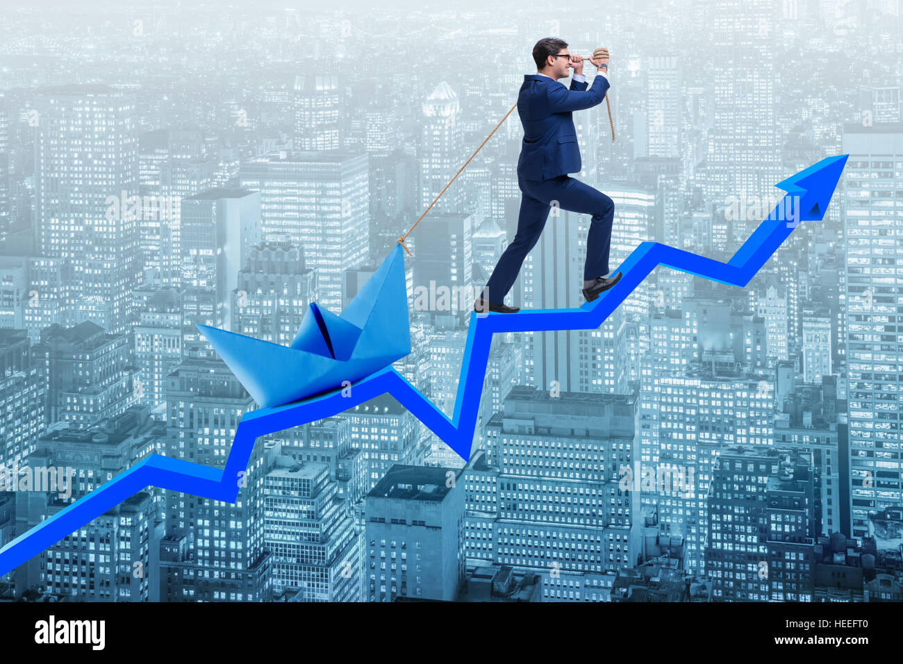 Businessman pulling boat over line chart Stock Photo - Alamy