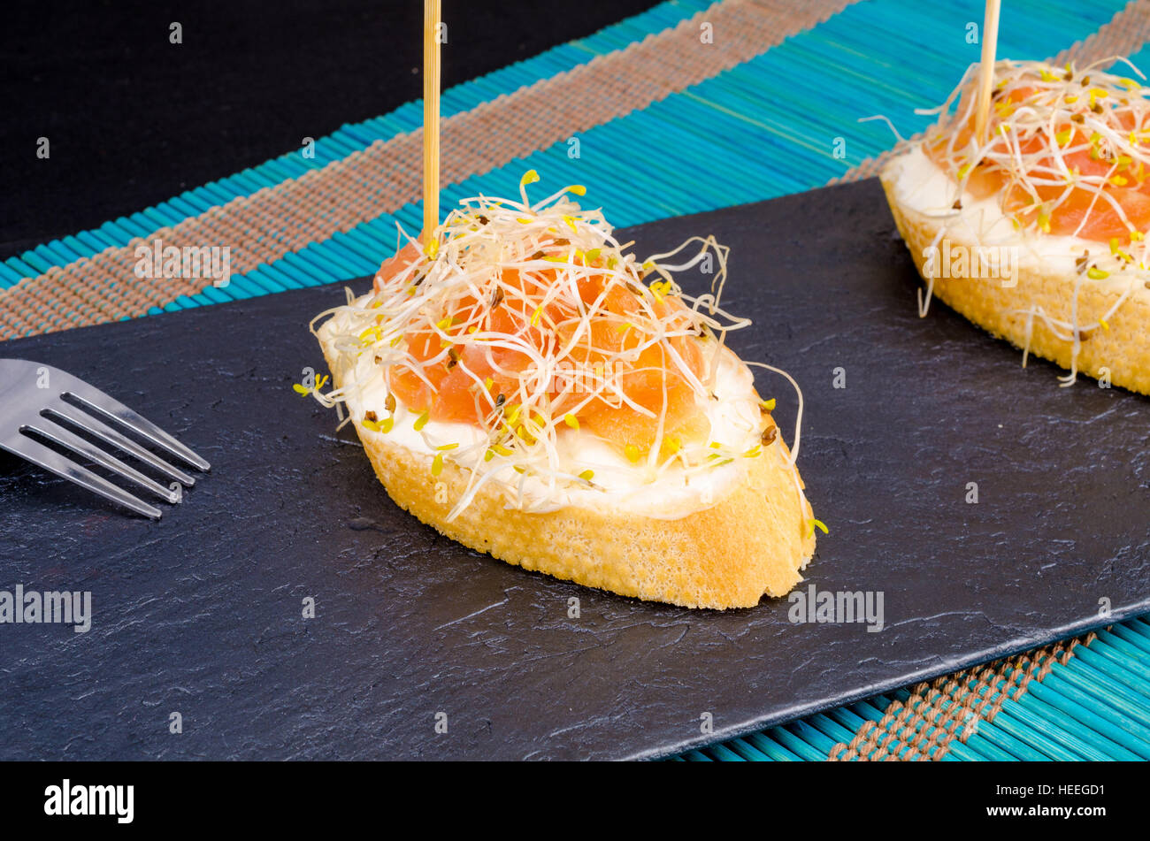 Pincho style salmon tapa served on goat cheese Stock Photo - Alamy