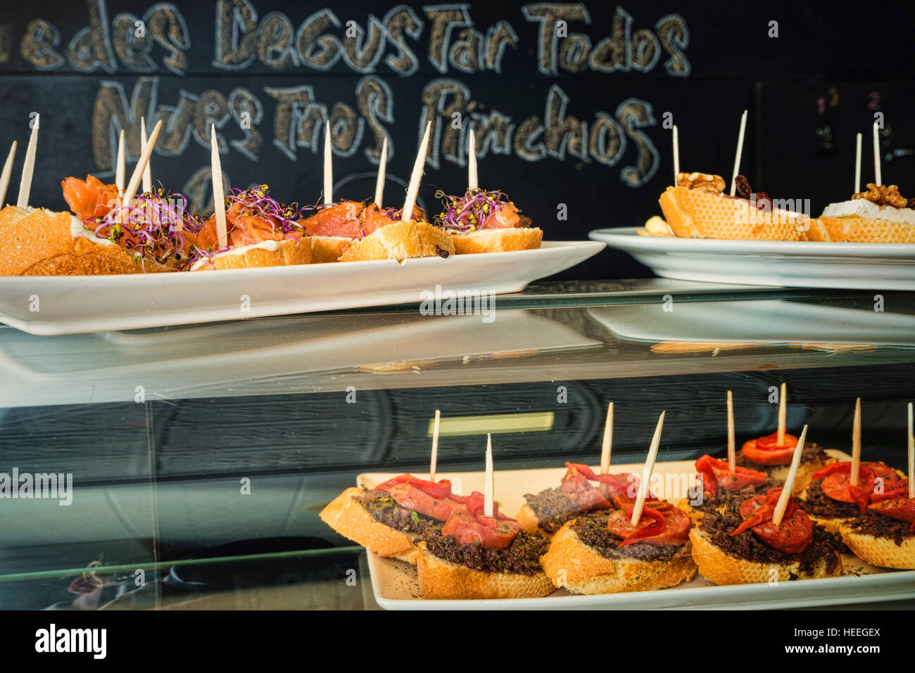 Tapas bar counter with assorted pincho tapas and a traditional ...