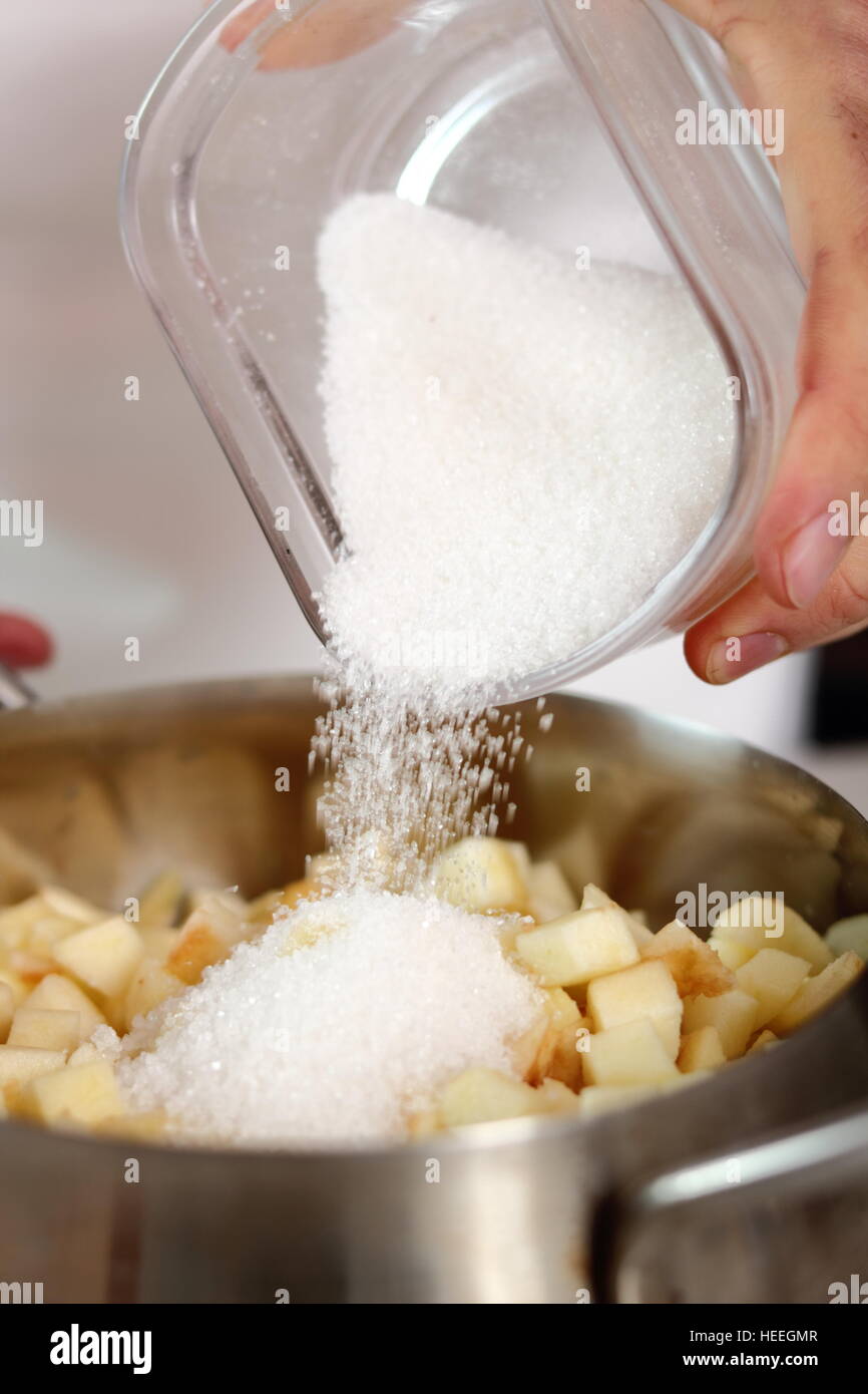Pouring sugar into saucepan with sliced apple. Making Filo Pastry ...