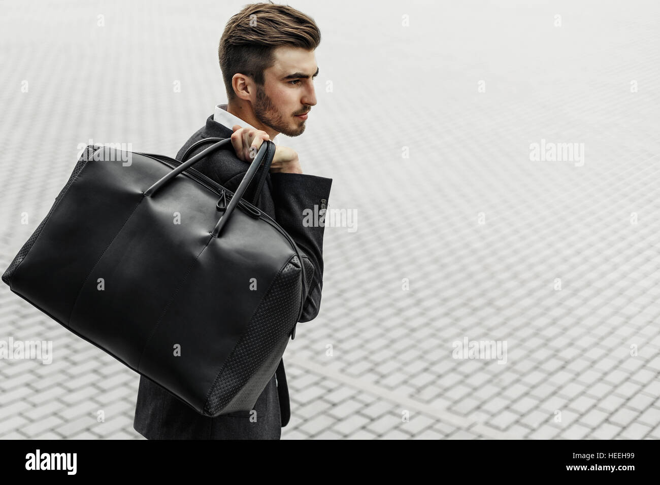 Rear view of handsome businessman with suitcase. Travelling guy concept ...
