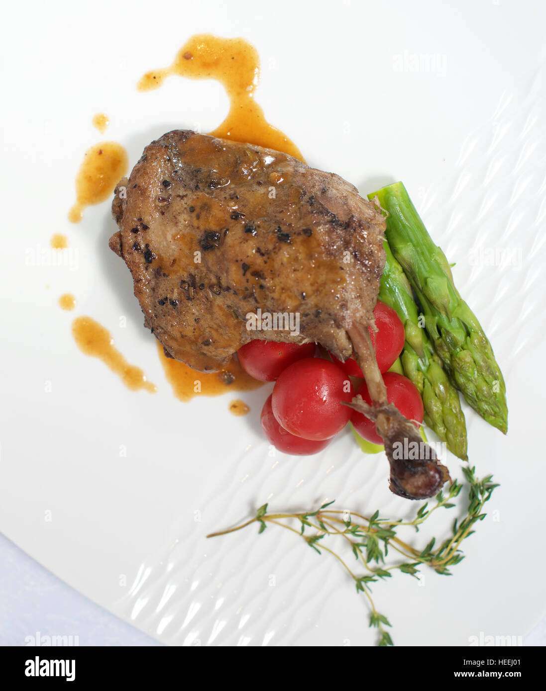 Duck leg dish on a white plate Stock Photo - Alamy