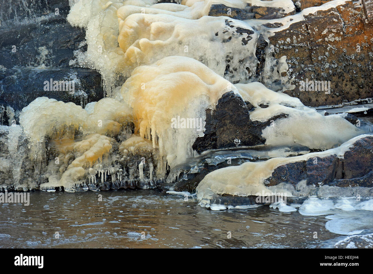 Ice and water on rocks Stock Photo - Alamy
