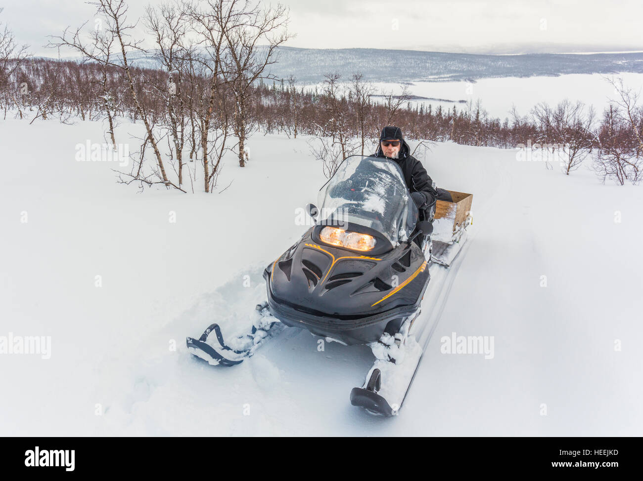 Man driving snowmobile hi-res stock photography and images - Alamy