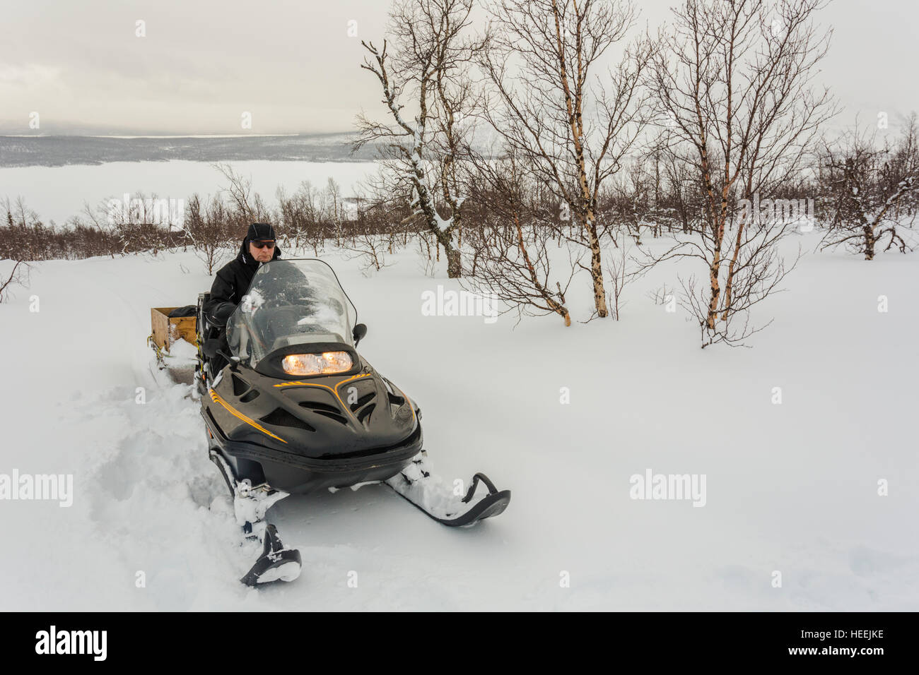 Man driving snowmobile hi-res stock photography and images - Alamy
