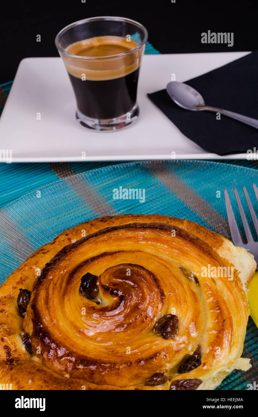 Sweet Spanish spiral bun served as a breakfast with coffee Stock Photo ...
