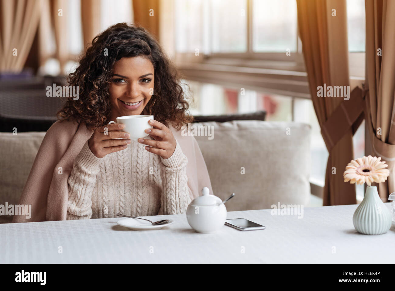 Smiling African American woman drinking the cup of tea Stock Photo - Alamy