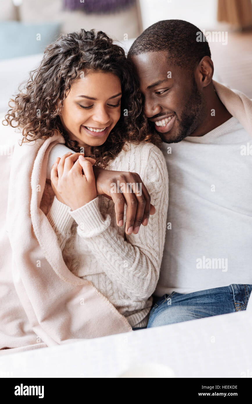 Cute young African American couple hugging in the cafe Stock Photo - Alamy