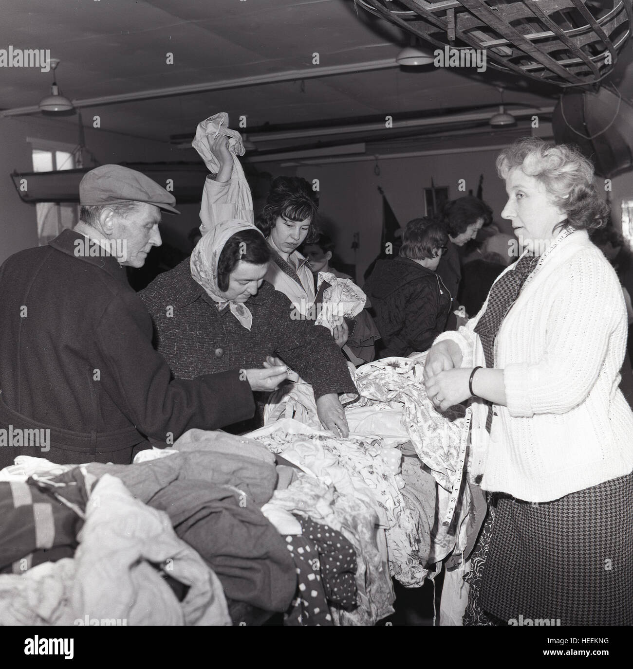 1965, historical, people rummage or look through the second-hand ...