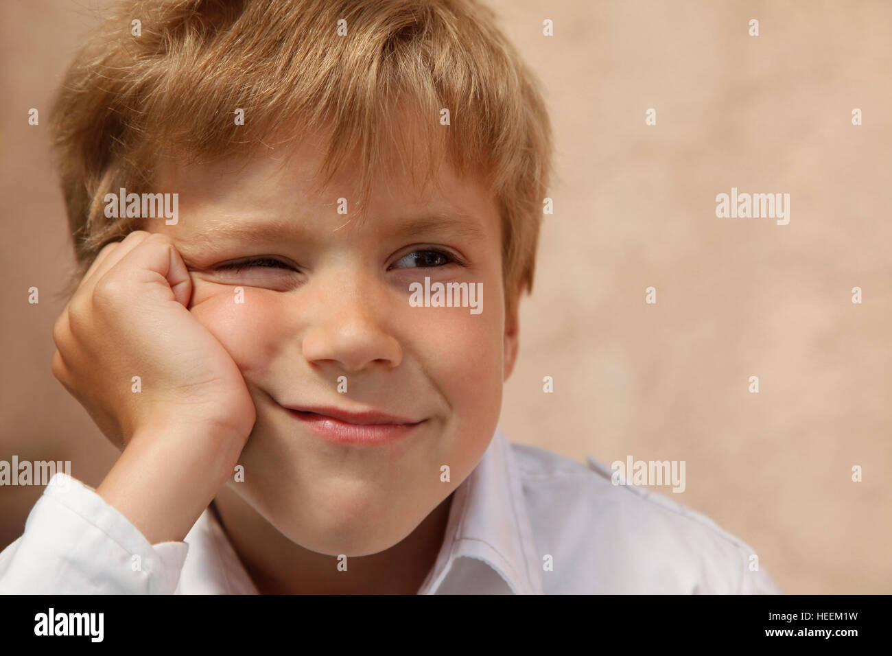 Portrait of the boy on a beige background Stock Photo - Alamy