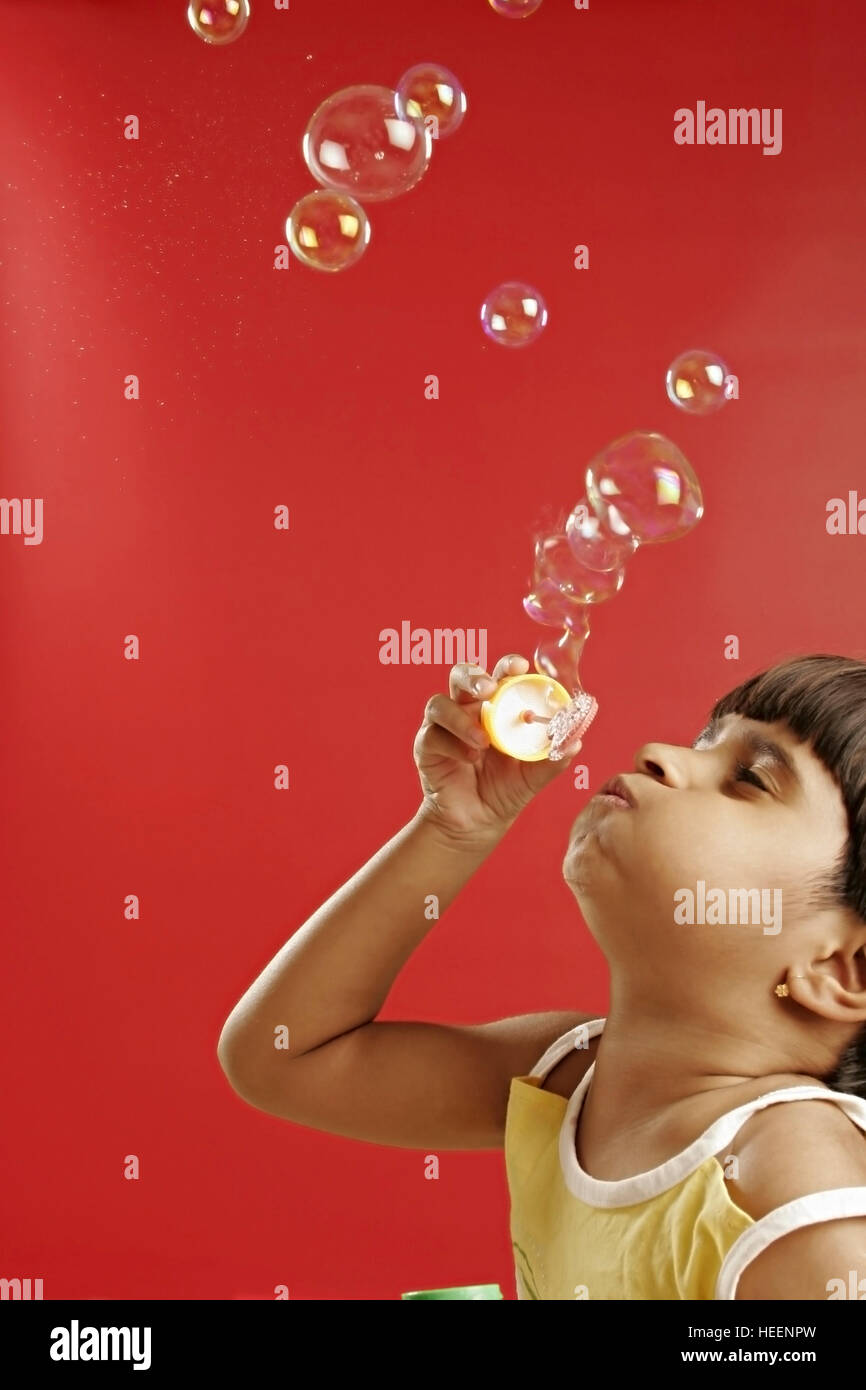 Young child blowing bubbles Stock Photo - Alamy