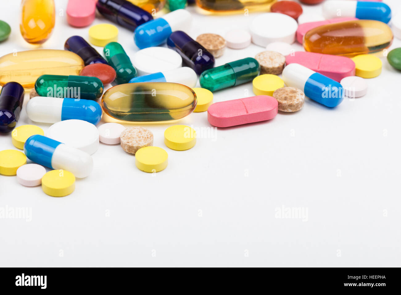 Bunch of color pills and capsules on white Stock Photo - Alamy