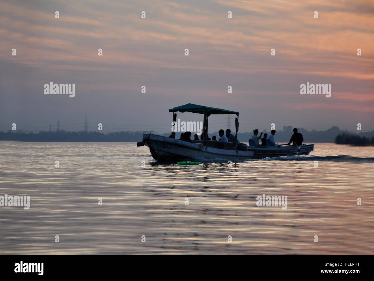 Silhouette people boating sea sky sunset boat hi-res stock photography ...