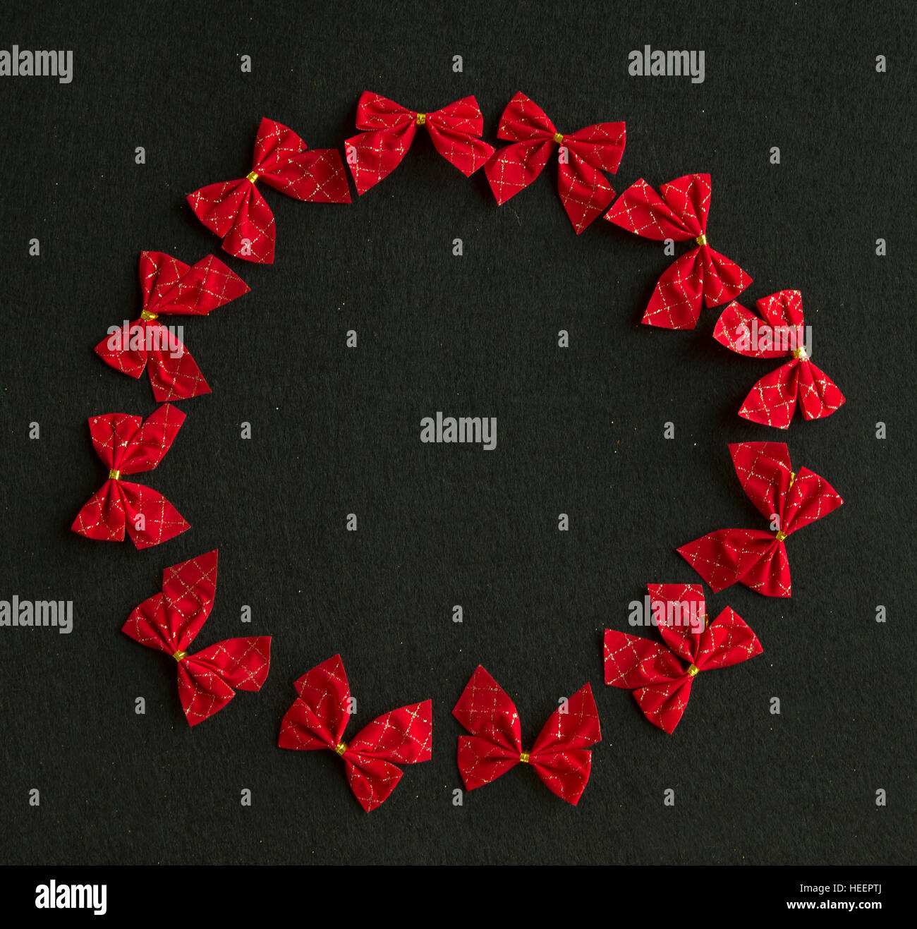 Red bows in circle on the black background Stock Photo - Alamy