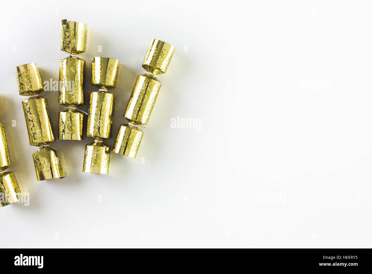 New Year Eve party gold crackers on a white background Stock Photo - Alamy