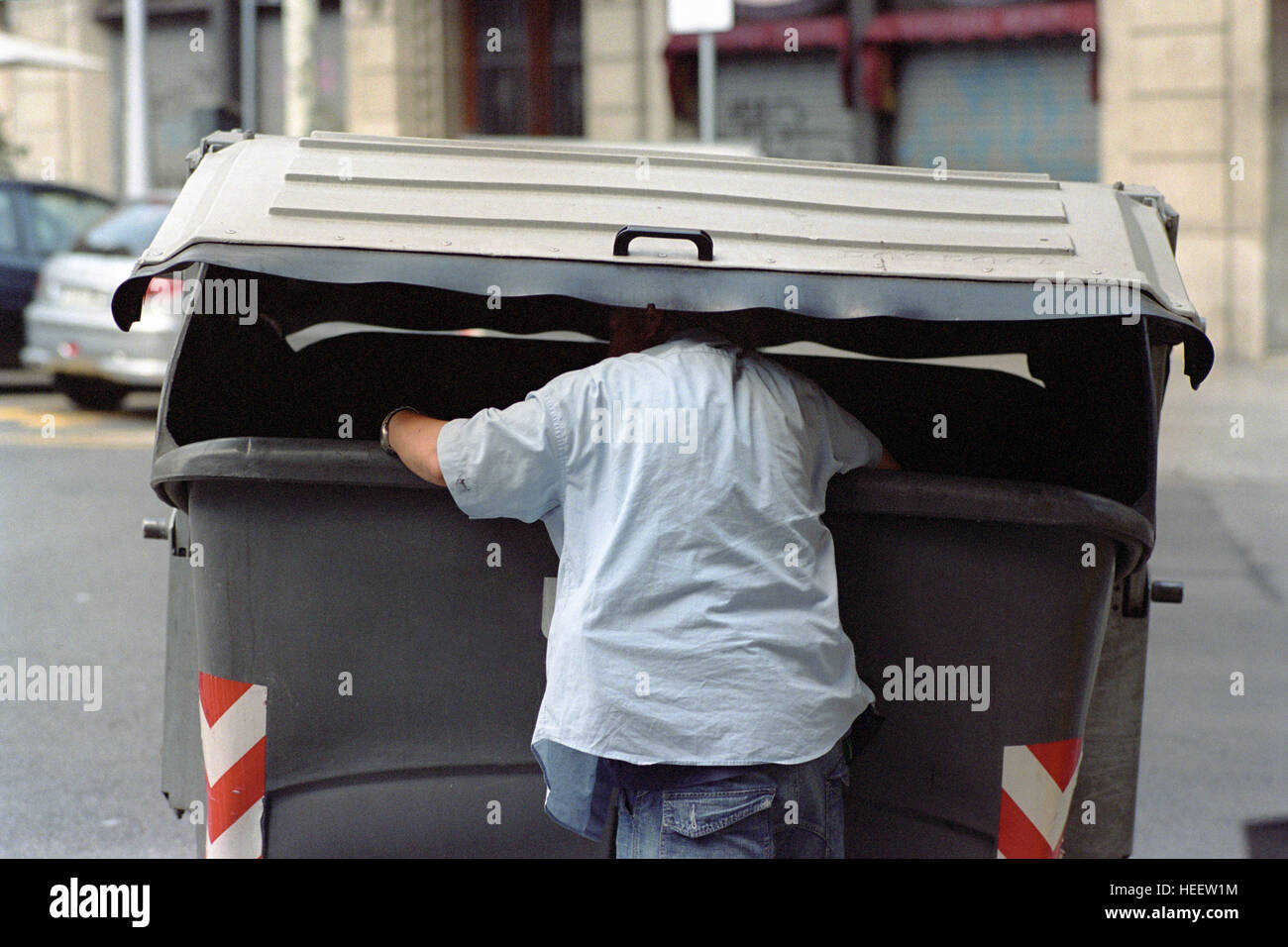 Dumpster diver Collecting Recyclables from the Garbage on the street of ...