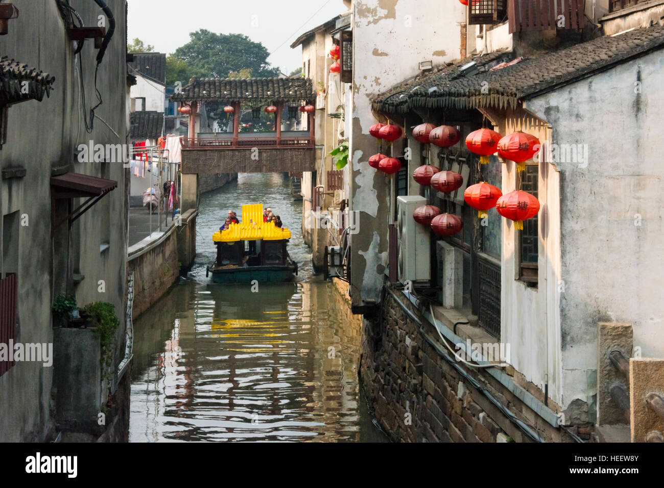 Traditional buildings and tourist boat on the Grand Canal, Suzhou ...