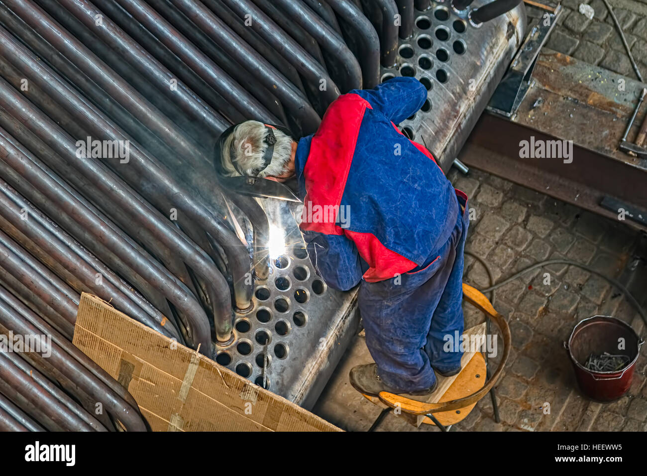 Welder welding metal pipes Stock Photo - Alamy