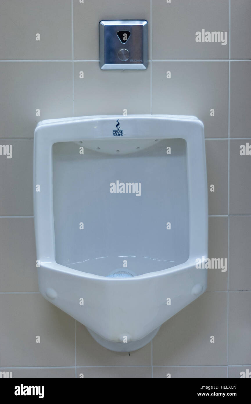 White male urinal unit in tiled wall in a public washroom Stock Photo ...