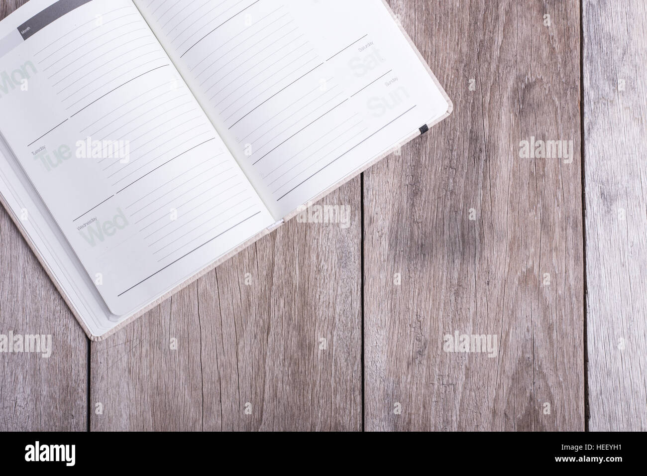 Top view of book on old wooden plank background Stock Photo - Alamy