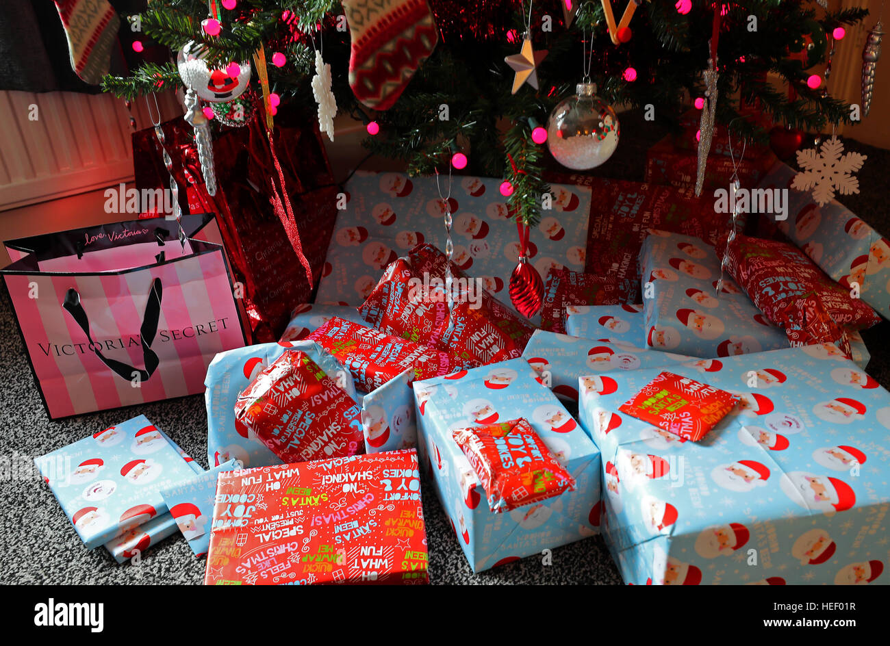 Presents wrapped and under a Christmas tree Stock Photo - Alamy