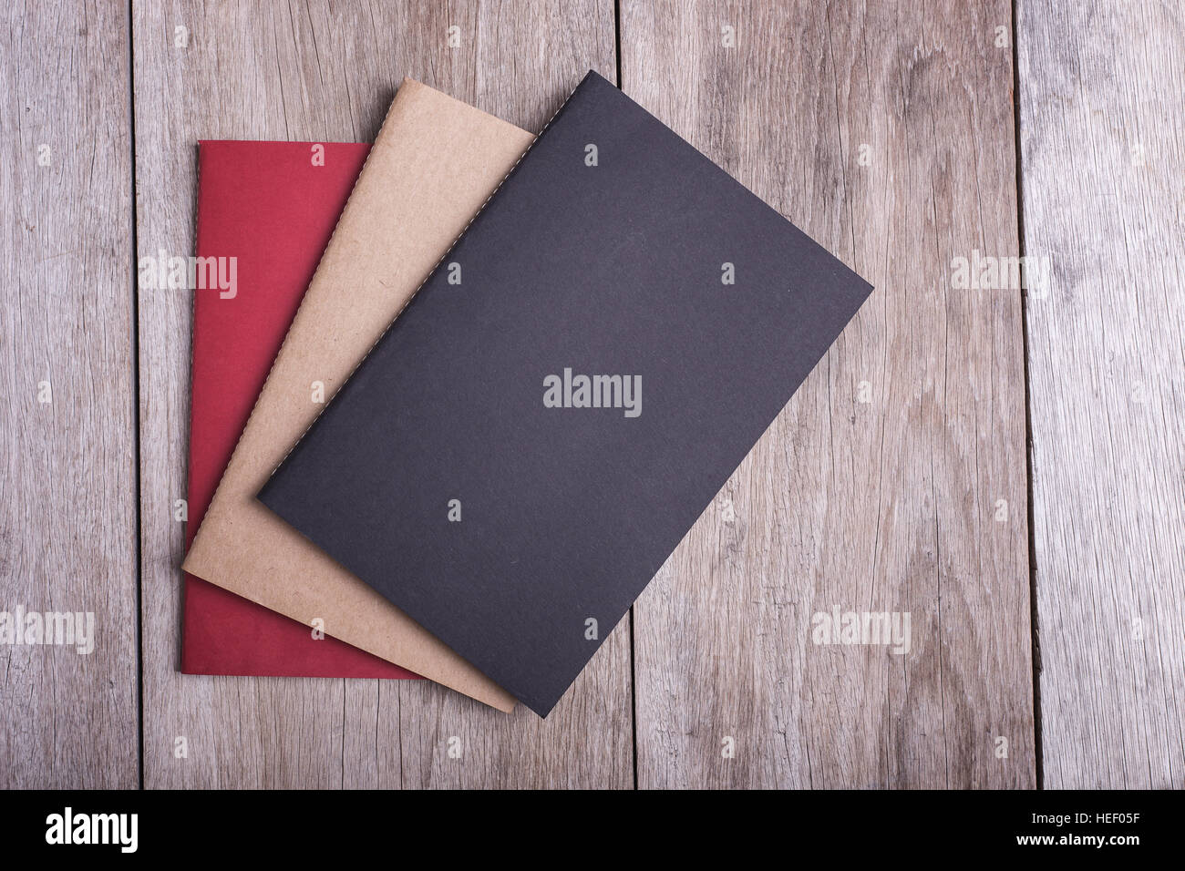 Top view of book on old wooden plank background Stock Photo - Alamy