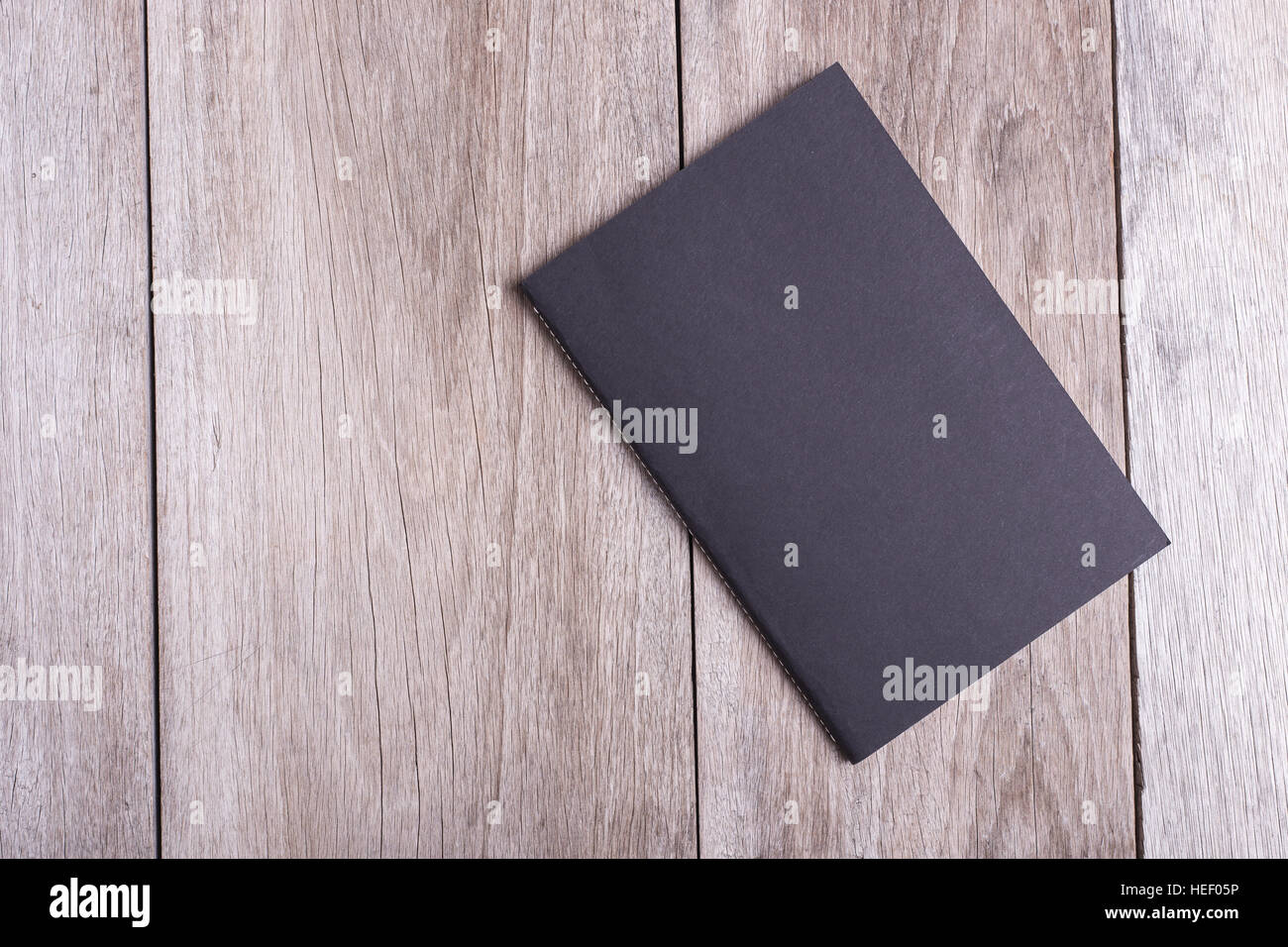 Top view of book on old wooden plank background Stock Photo - Alamy