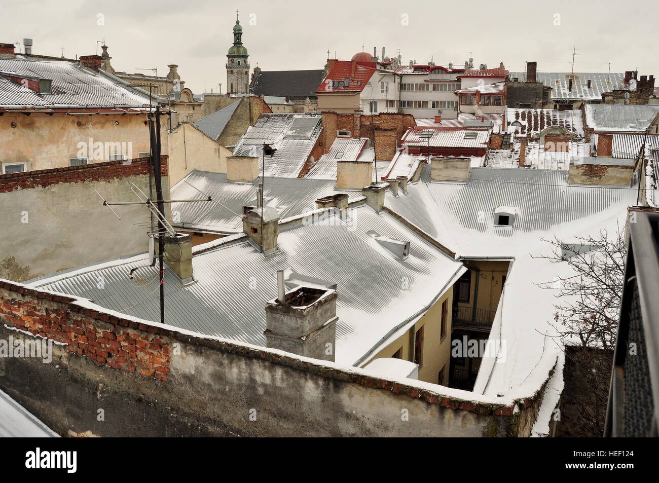 Old buildings and snow-covered roofs. Winter view of the downtown in ...