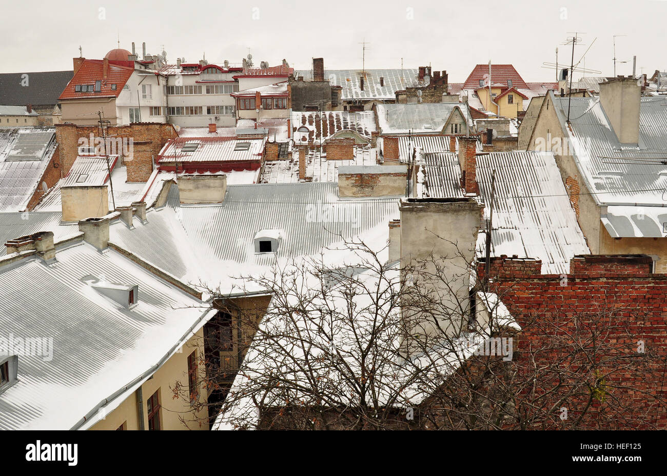 Old buildings and snow-covered roofs. Winter view of the downtown in ...
