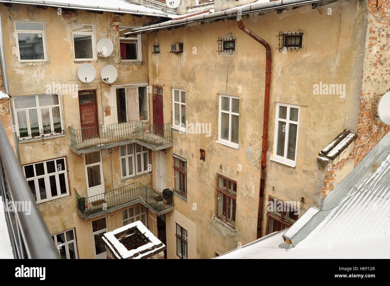 Old buildings and snow-covered roofs. Winter view of the downtown in ...