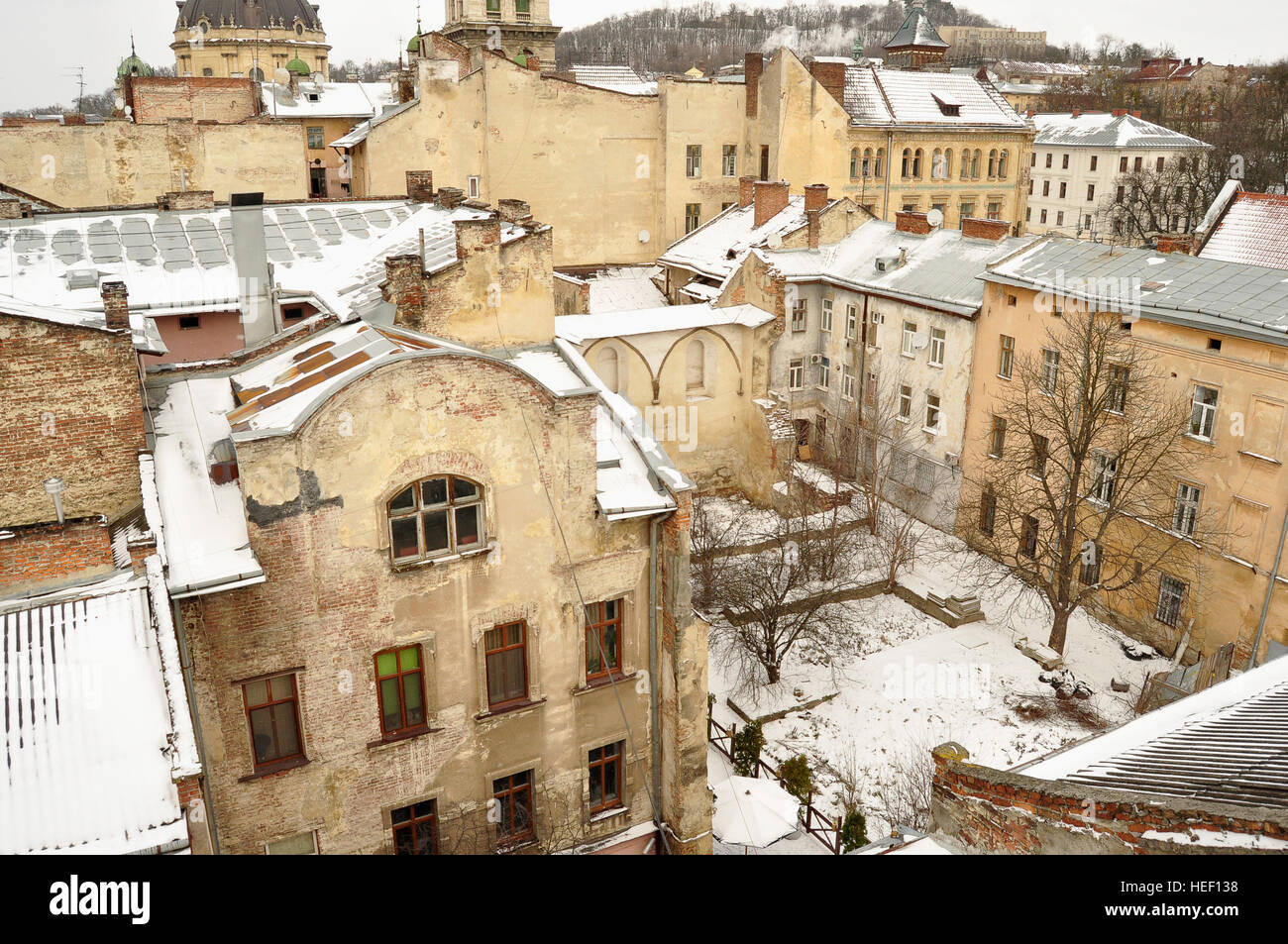 Old buildings and snow-covered roofs. Winter view of the downtown in ...