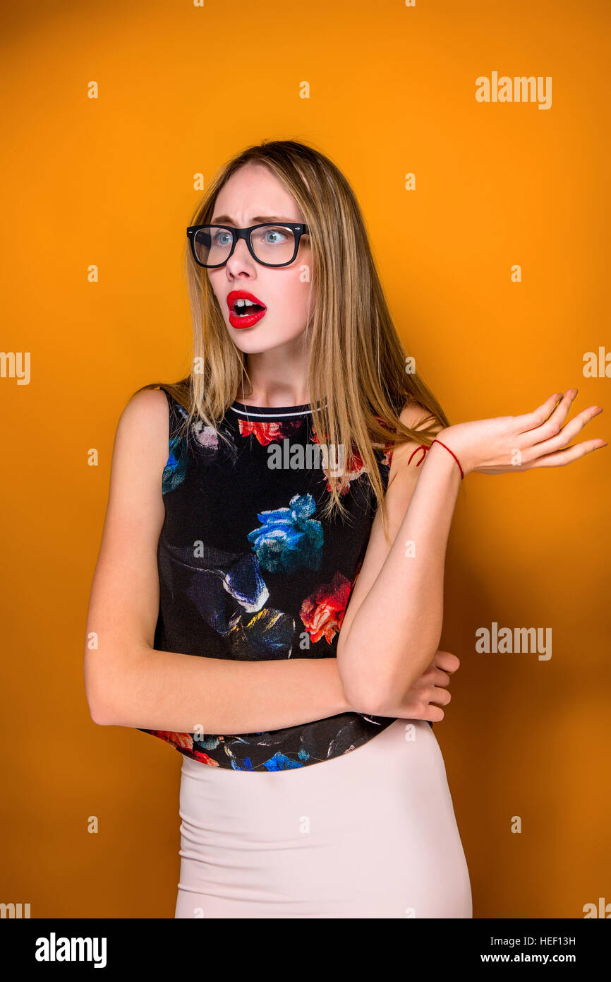Portrait of young woman with glasses and shocked facial expression on ...
