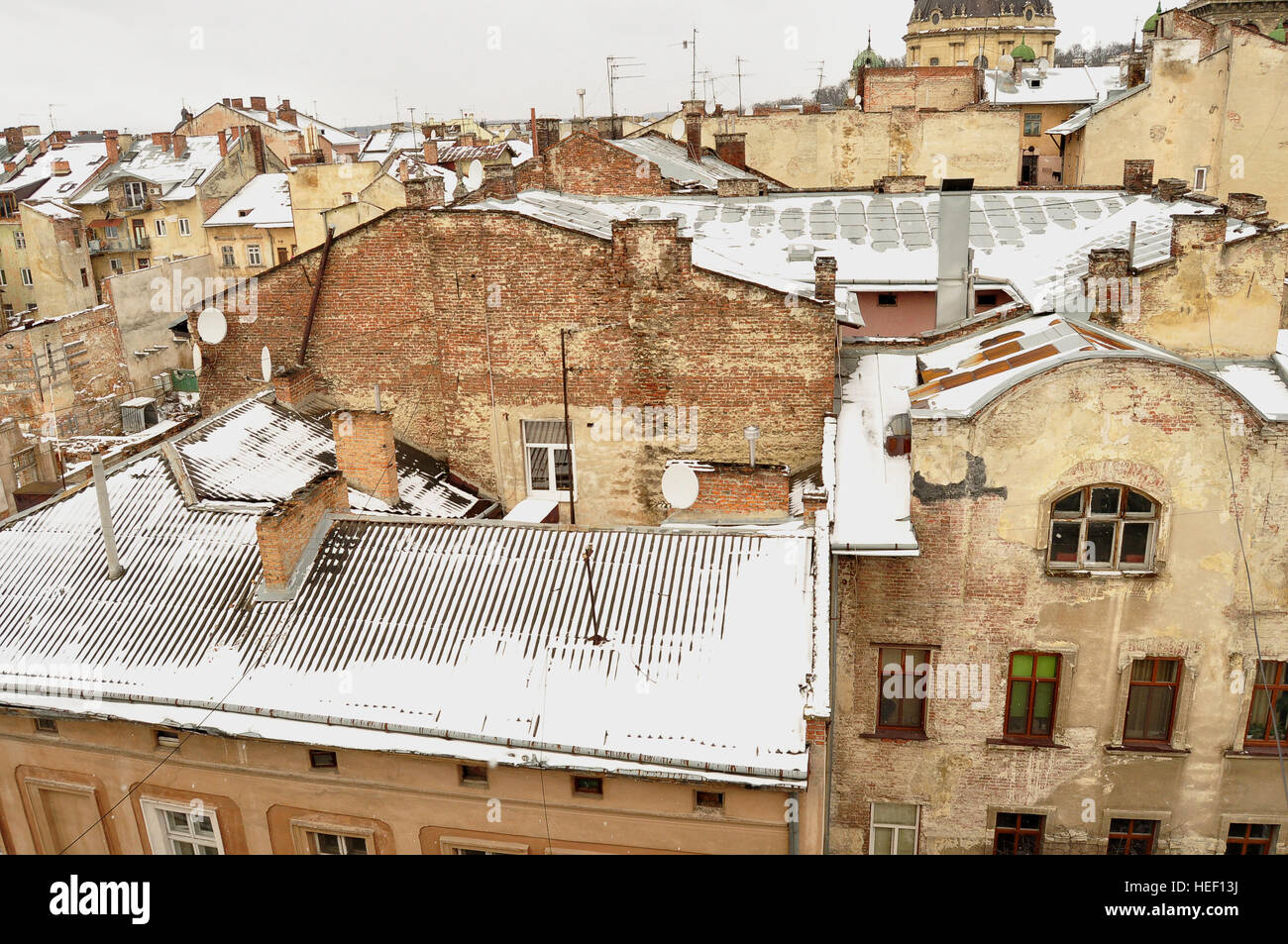 Old buildings and snow-covered roofs. Winter view of the downtown in ...