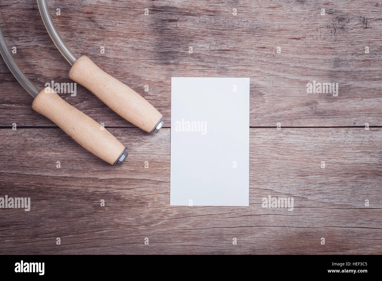 Close up skipping rope and blank paper on wooden table top view Stock ...