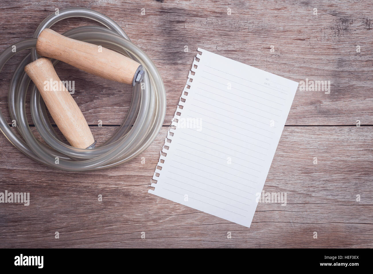 Close up skipping rope and lined paper on wooden table top view Stock ...