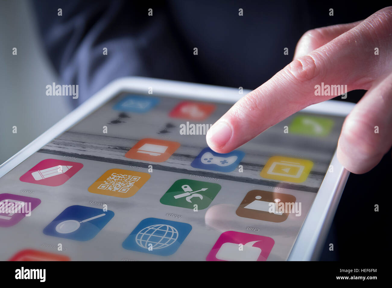 finger touches digital tablet showing apps on screen Stock Photo - Alamy