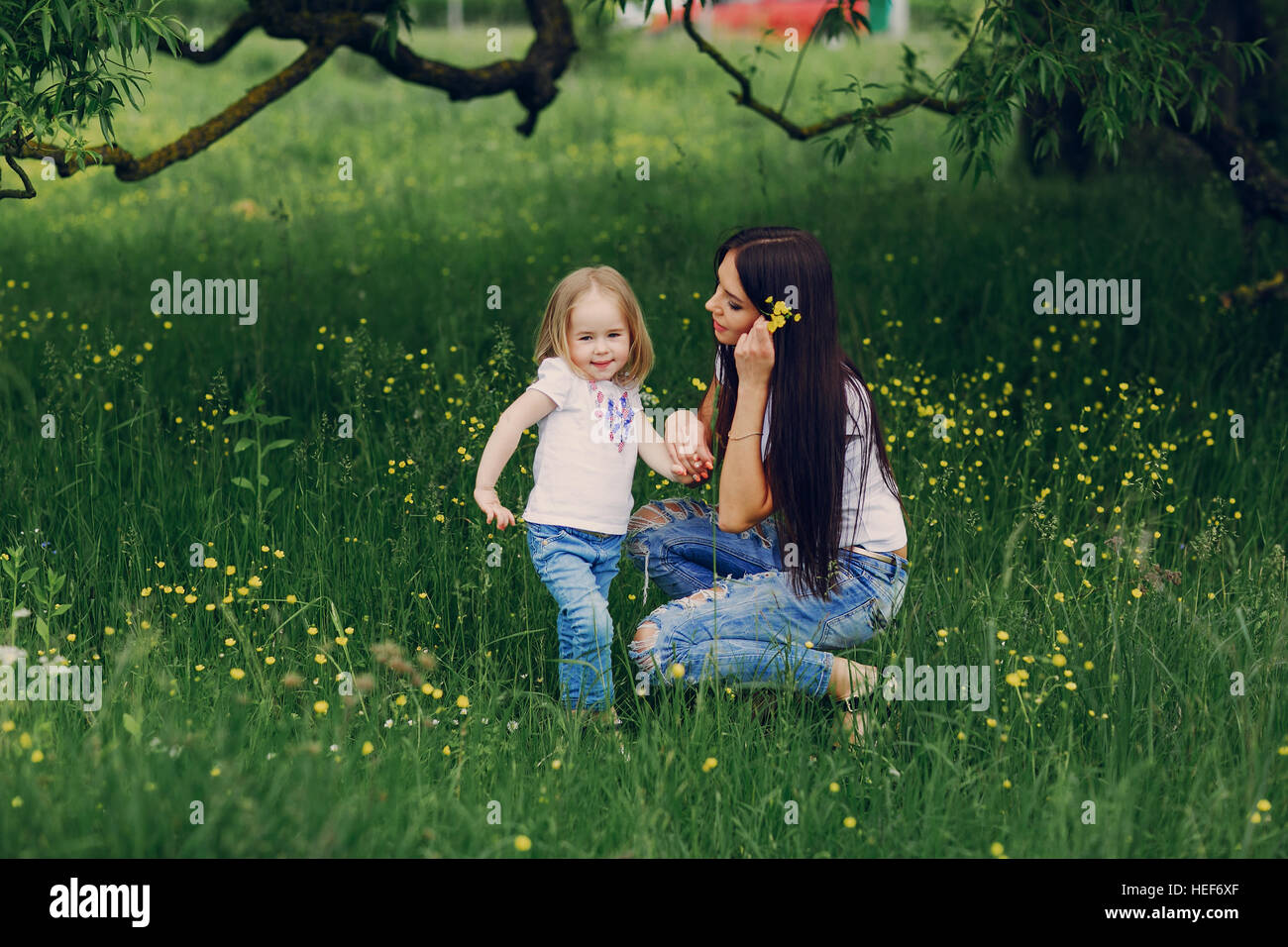 child near tree with mom Stock Photo - Alamy