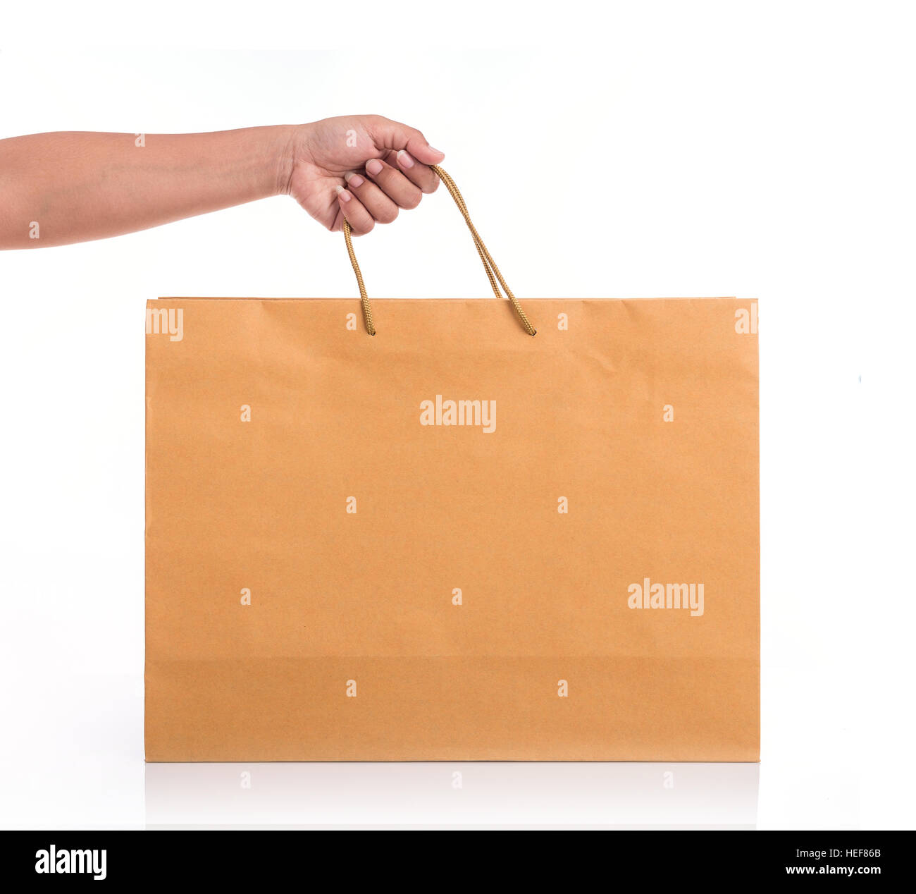 Close up hand holding brown paper bag isolated on white background ...