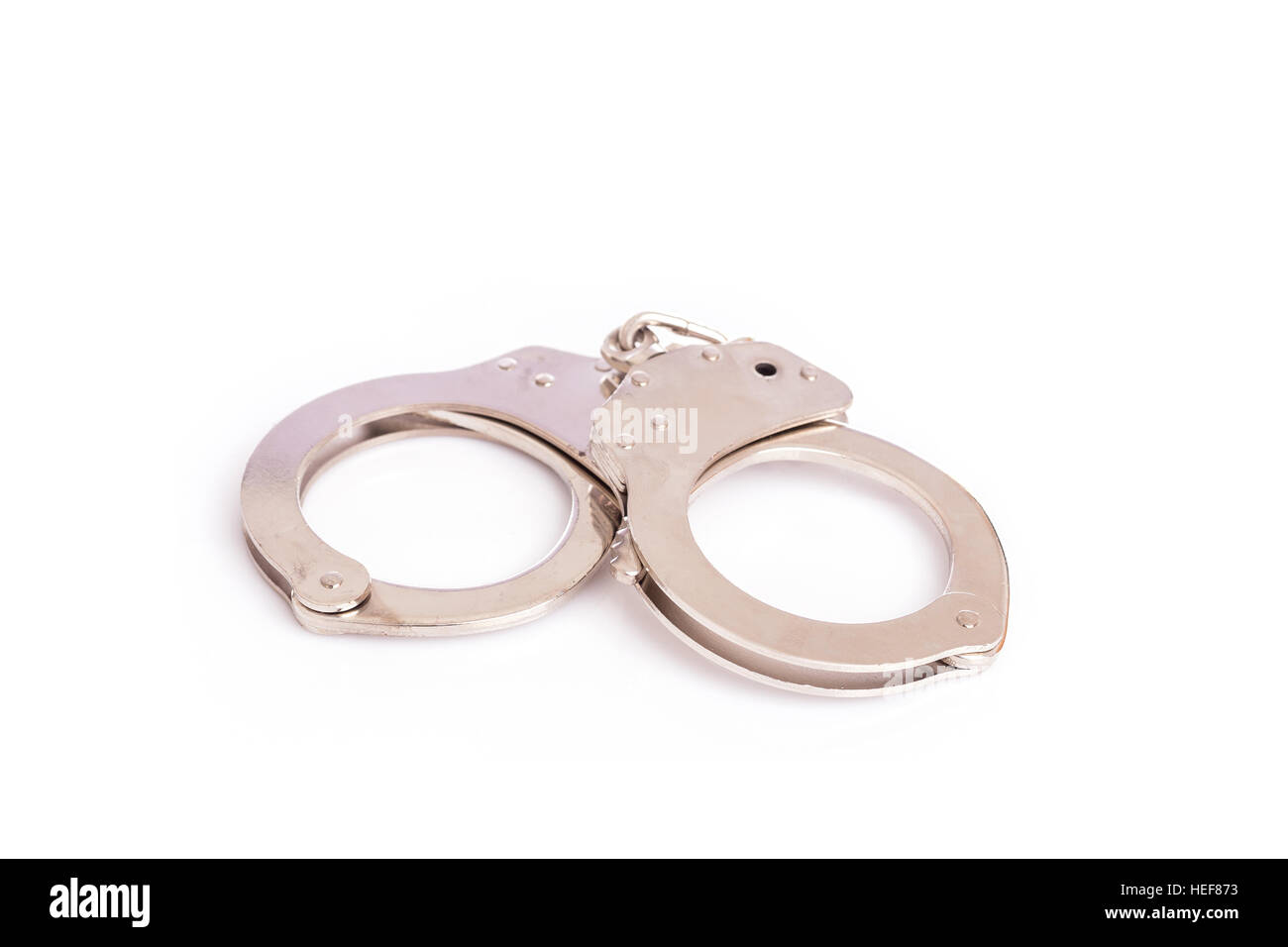 Closeup shot handcuffs isolated Cut Out Stock Images & Pictures - Alamy