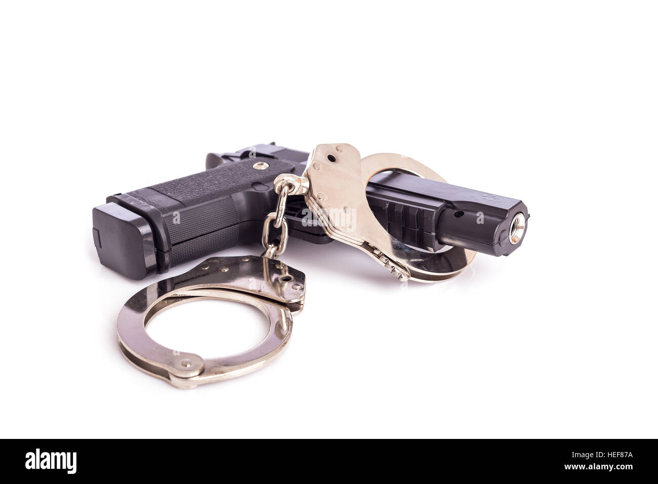 Close up gun and handcuffs isolated on white background Stock Photo - Alamy Close up gun and handcuffs isolated on white background Stock Photo - Alamy