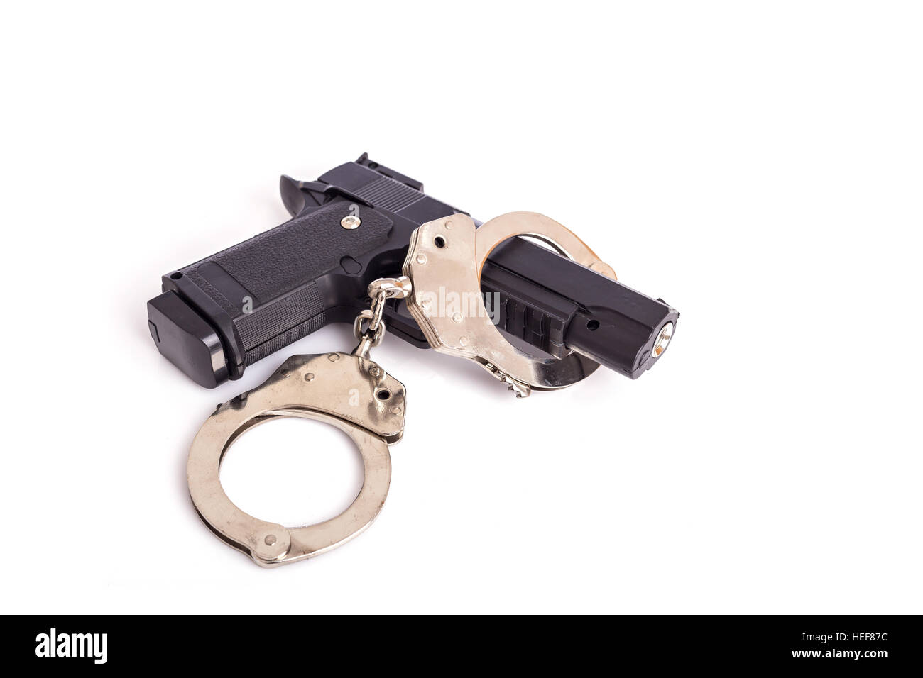 Close up gun and handcuffs isolated on white background Stock Photo - Alamy Close up gun and handcuffs isolated on white background Stock Photo - Alamy