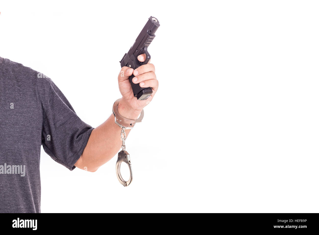 Close up man with handcuffs and gun on hands isolated on white ...