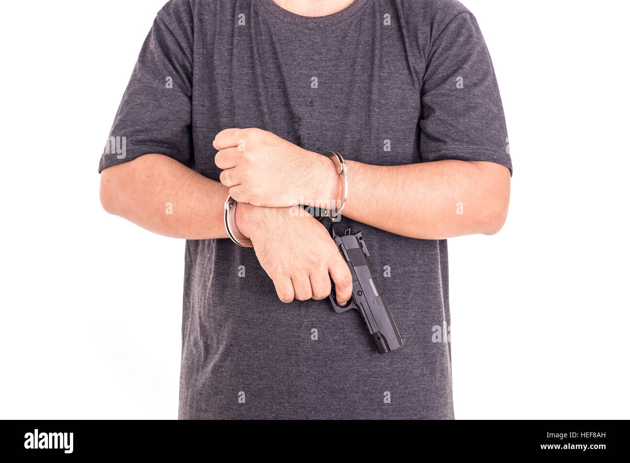 Close up man with handcuffs and gun on hands isolated on white ... Close up man with handcuffs and gun on hands isolated on white ...