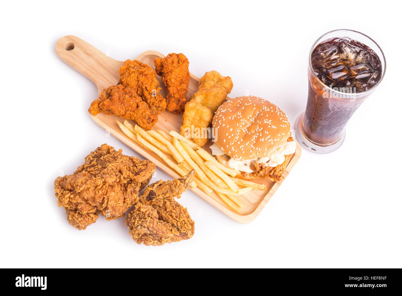 Close up fried chicken, french fries and soft drink on wooden table ...